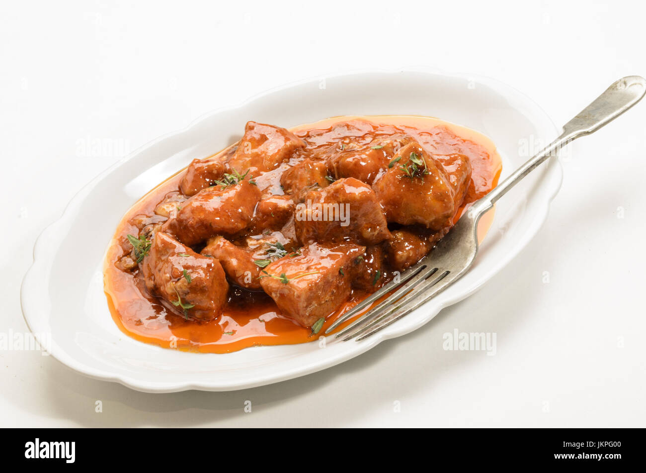 hungarian style chicken goulash on a white plate Stock Photo - Alamy