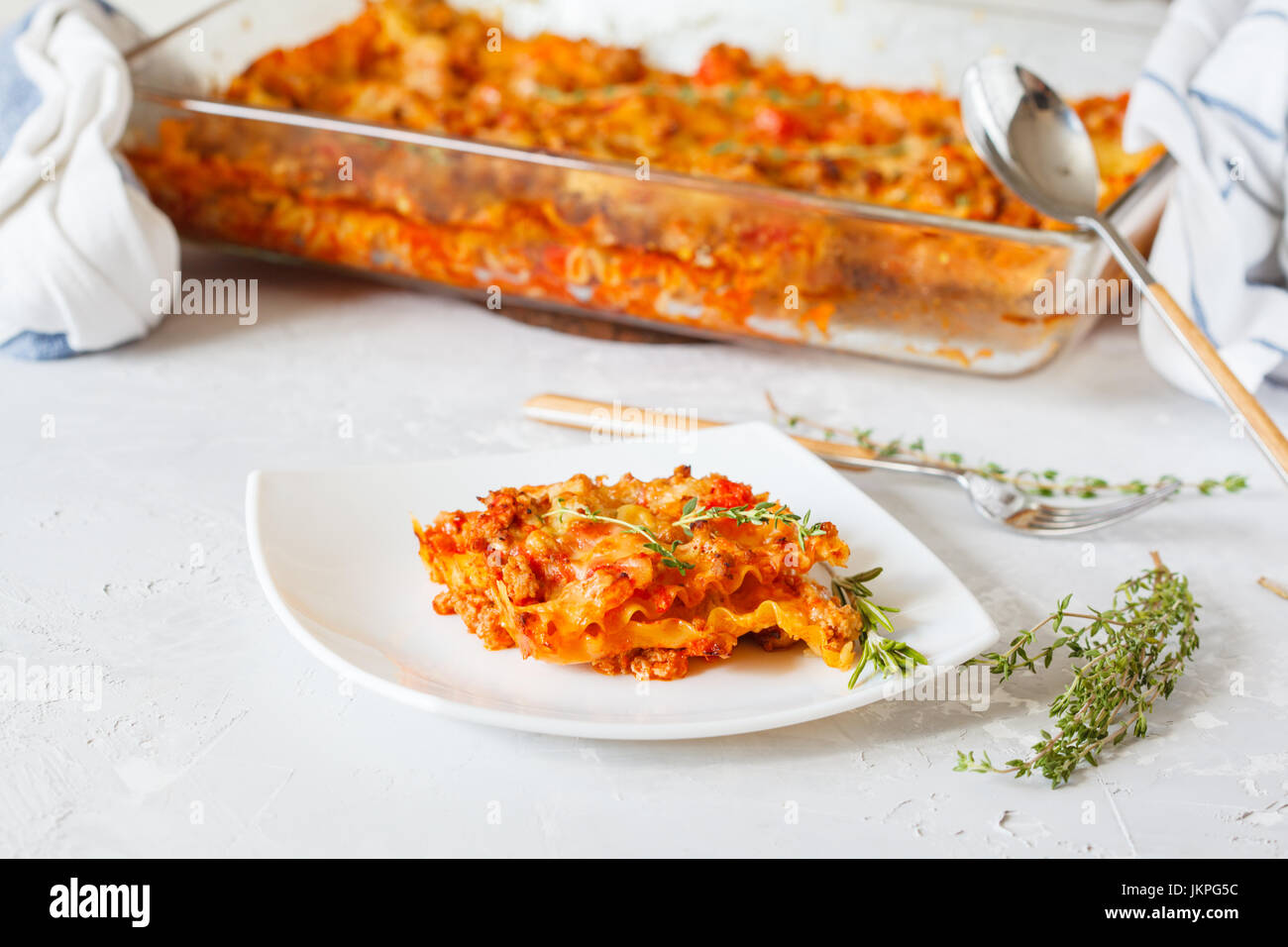 Traditional Italian lasagna baked with herbs and a piece of lasagna on ...