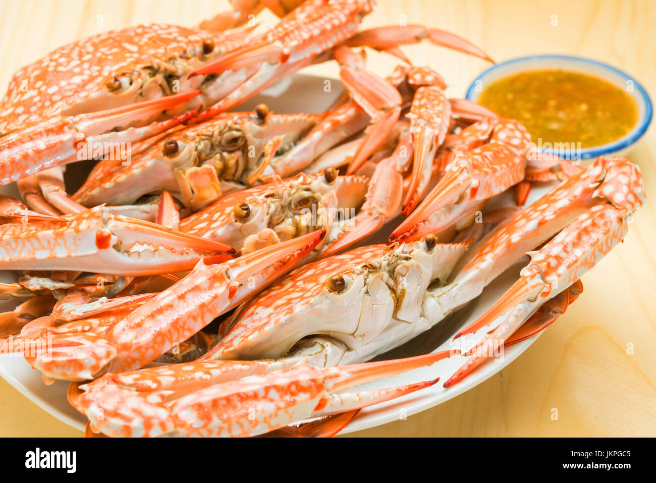 Flower crab group steamed on wood background with sauce Stock Photo - Alamy