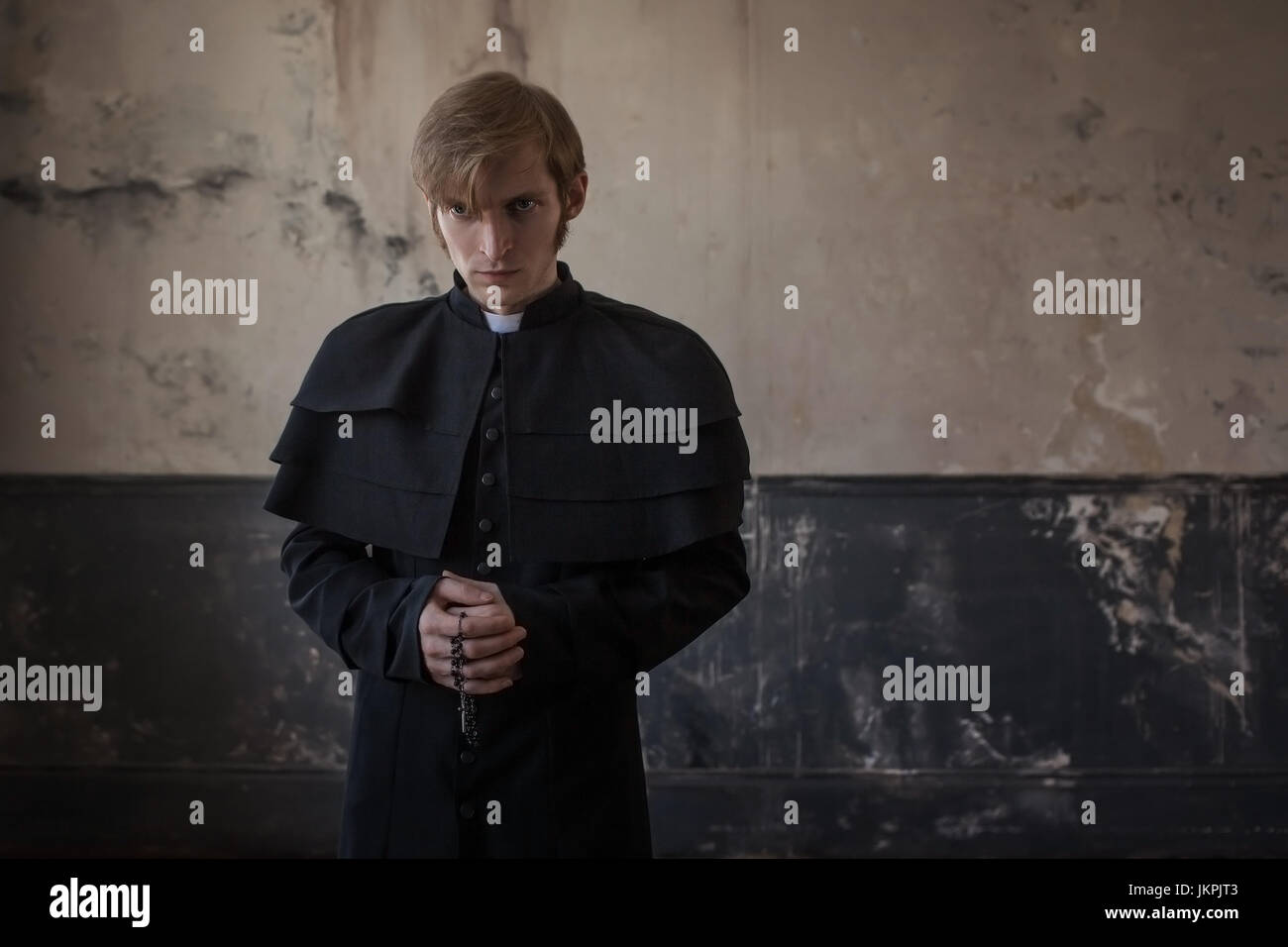 Portrait of handsome young catholic priest looking at you. Prayer Stock ...