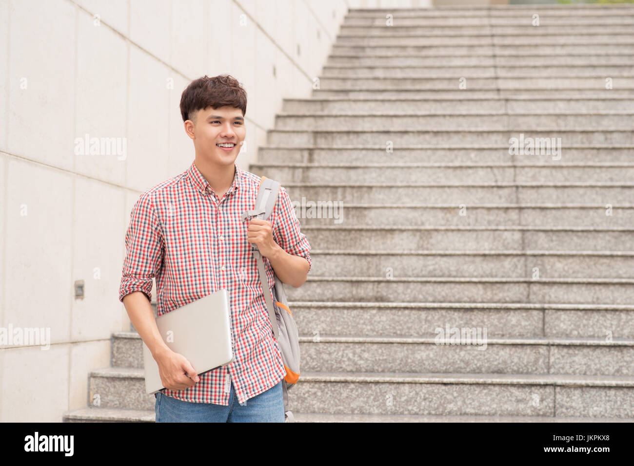 Male student hold with laptop computer at university campus Stock Photo ...