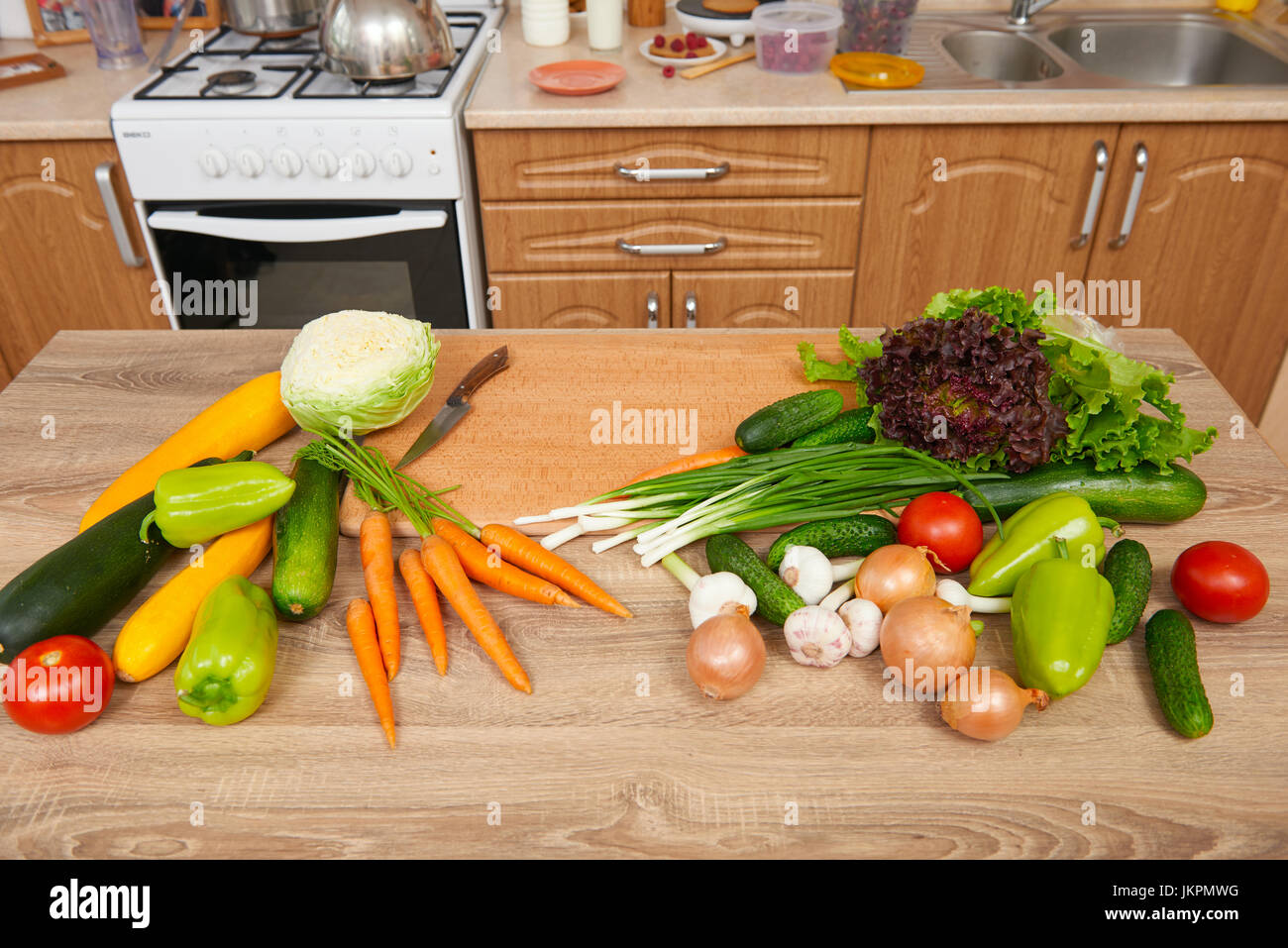 fresh fruits and vegetables on the table in kitchen interior, healthy ...