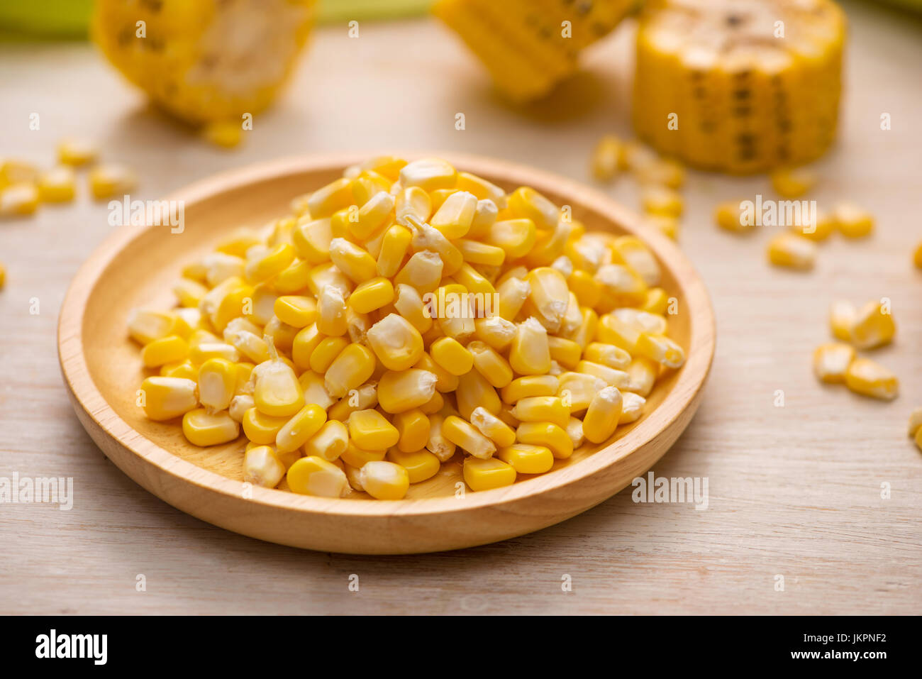 Sweet corn seeds on a wooden plate Stock Photo - Alamy