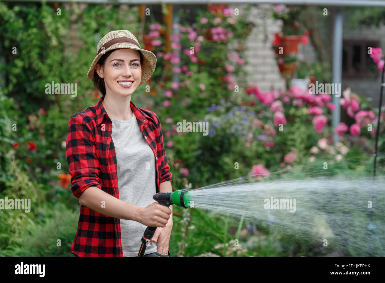 woman gardener watering garden Stock Photo - Alamy