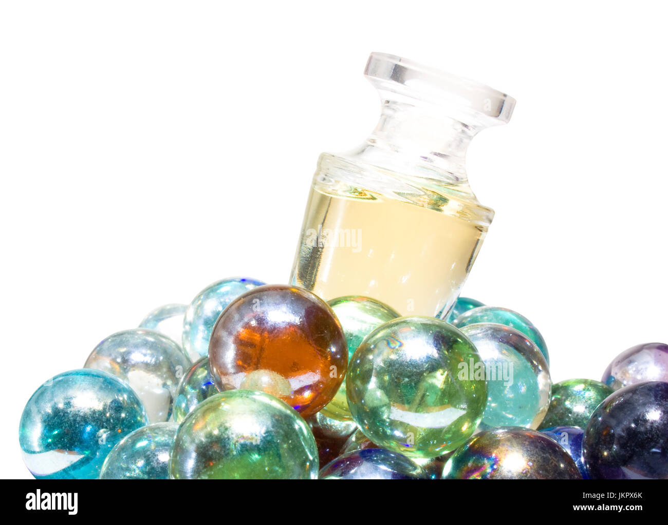 Luxury perfume on heap of colorful glass balls. Isolated on white, copy ...