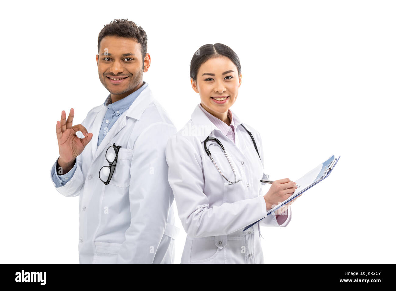 Young professional doctors standing together and gesturing isolated on ...