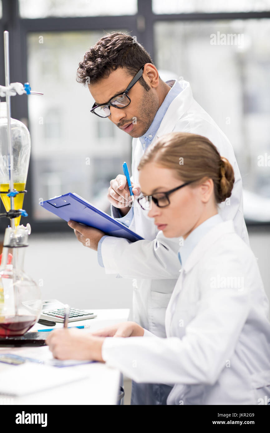 side view of scientists working in laboratory Stock Photo - Alamy
