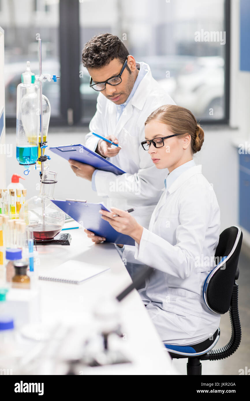 side view of scientists working in laboratory Stock Photo - Alamy