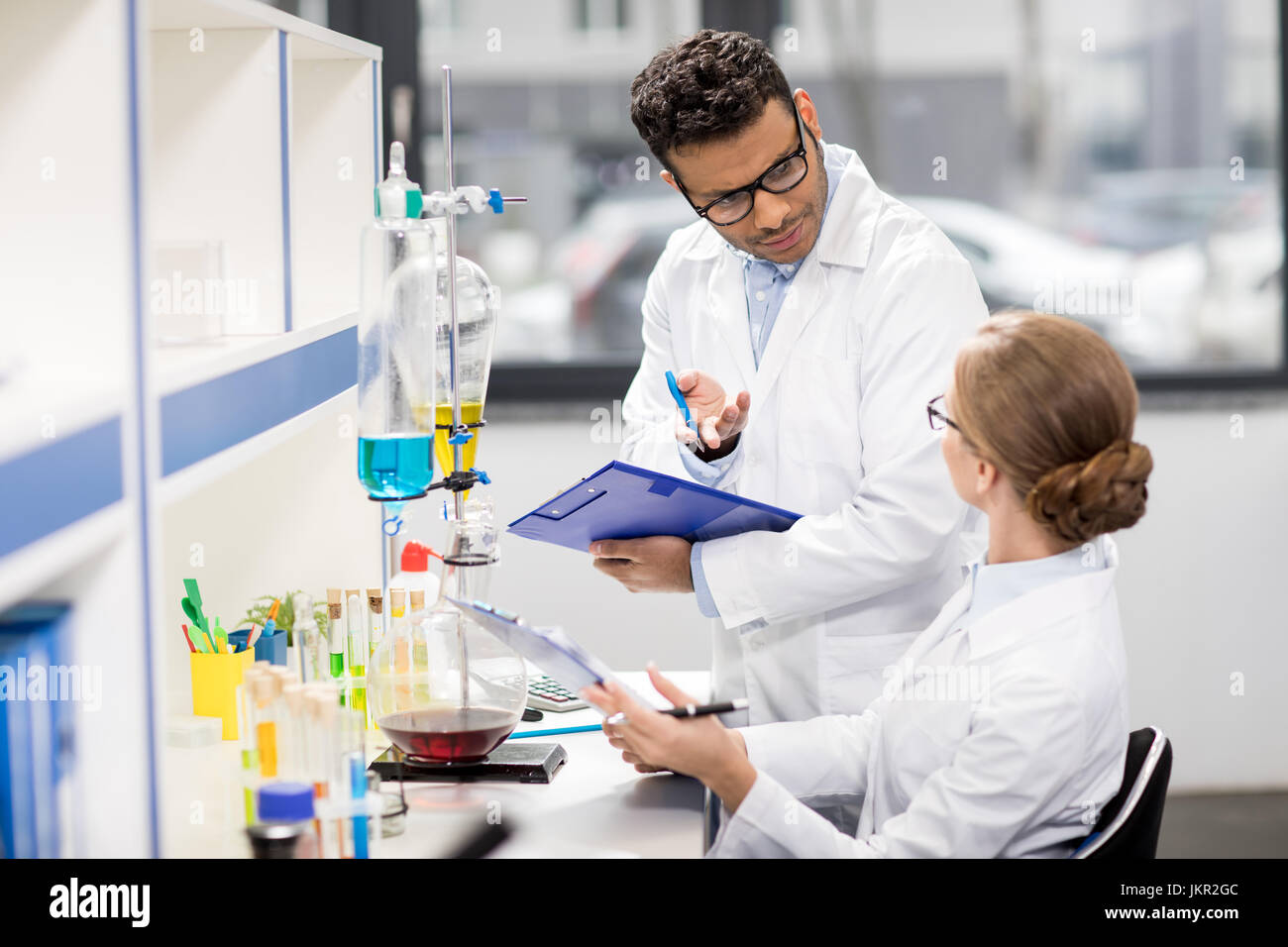 side view of scientists working in laboratory Stock Photo - Alamy