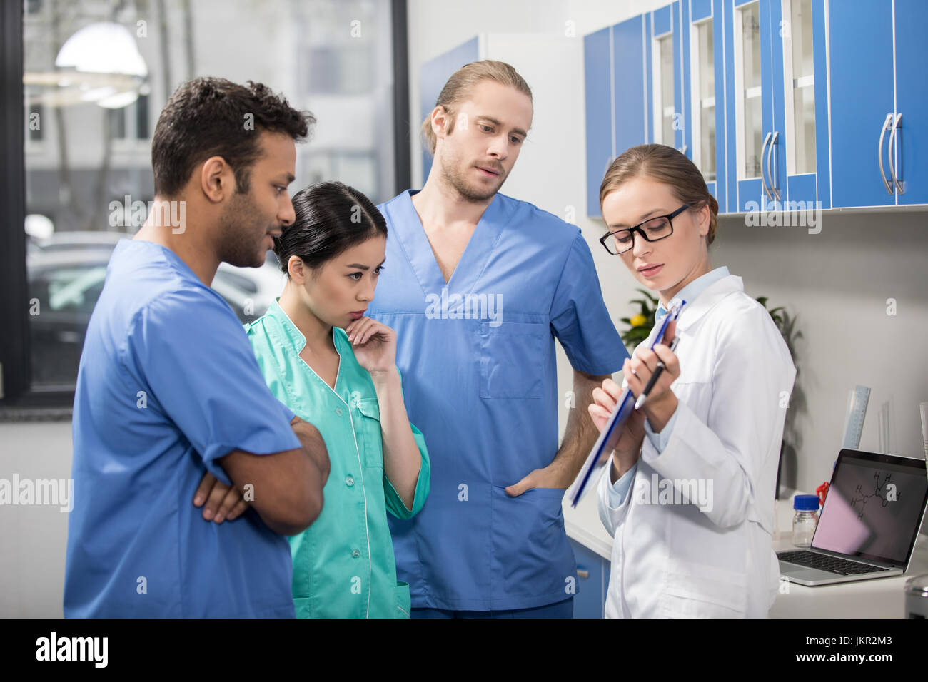 group of colleagues discussing work in laboratory Stock Photo - Alamy