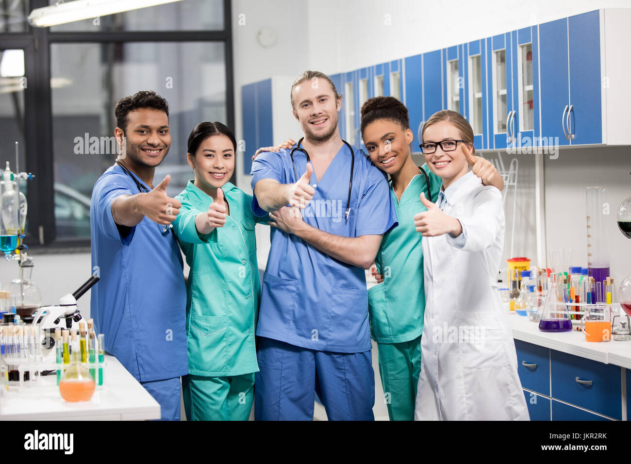 group of smiling medical workers showing thumbs up in laboratory Stock ...