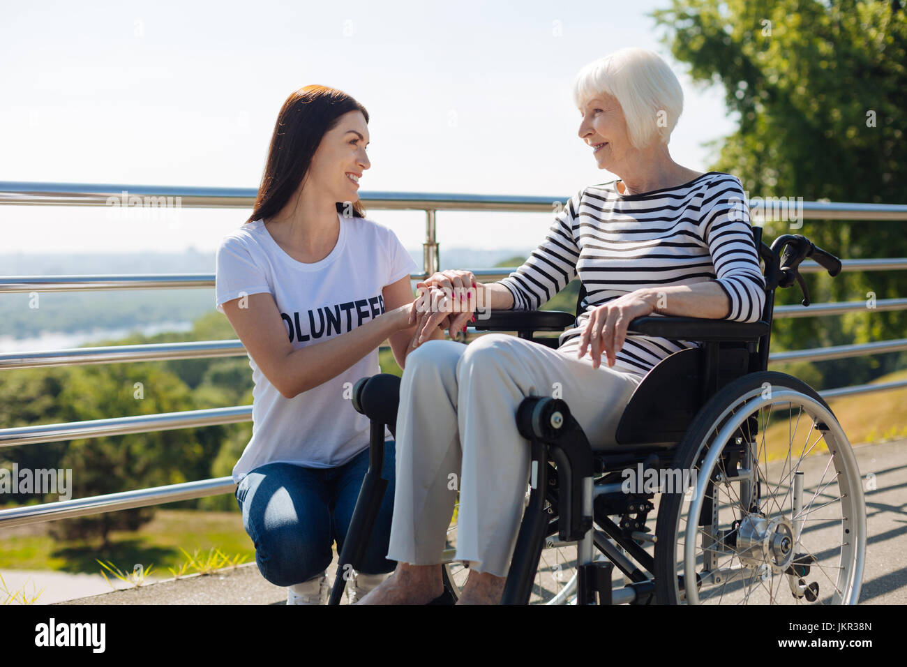Brilliant genuine woman appreciating volunteers help Stock Photo - Alamy