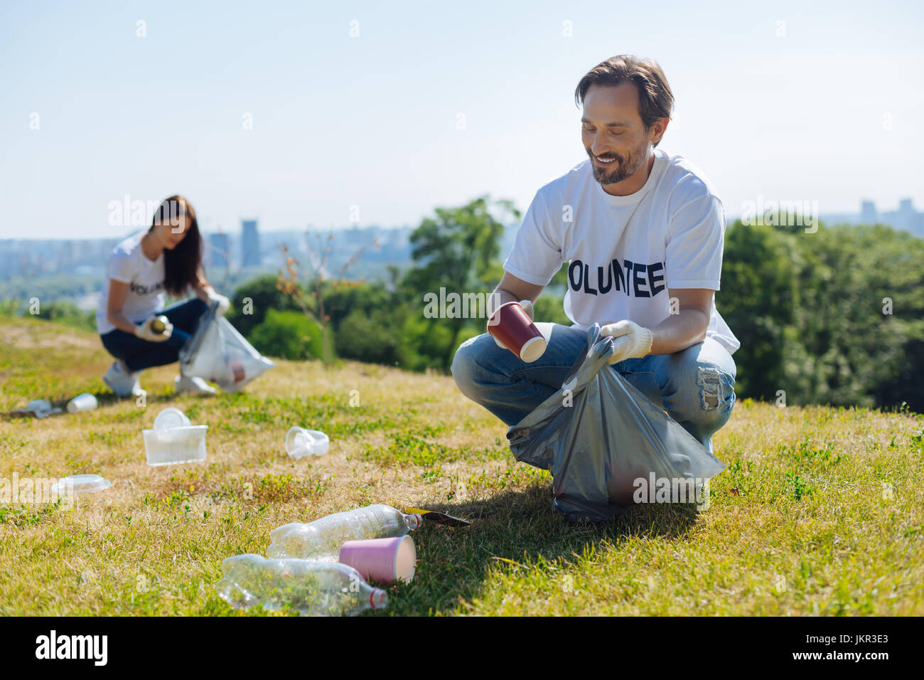 Focused motivated man cleaning local park from litter Stock Photo - Alamy