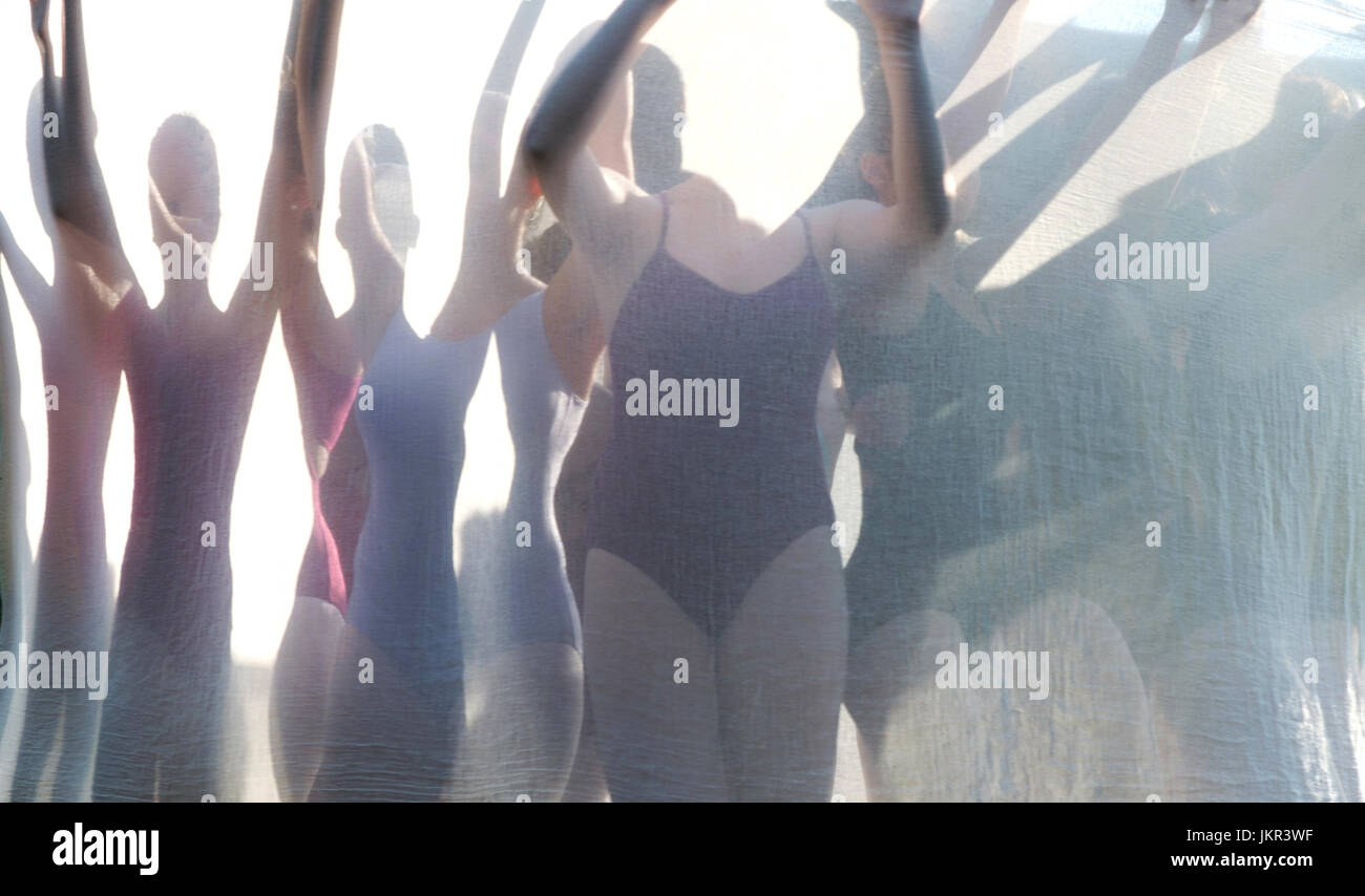 Young ballerinas dancing behind a white transparent cloth Stock Photo ...