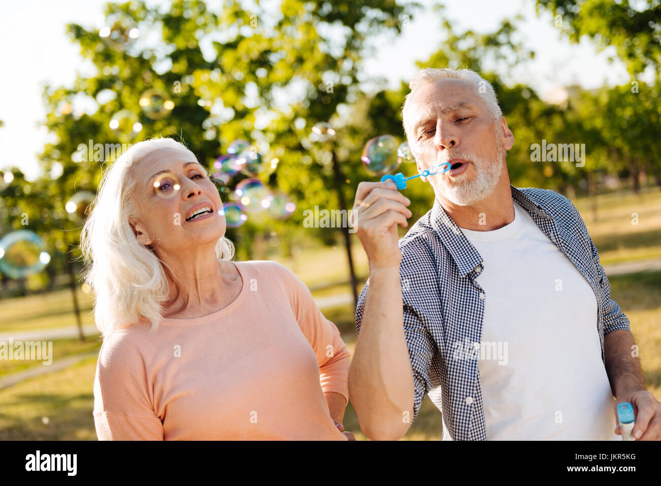 Relaxed mature man blowing bubbles Stock Photo - Alamy