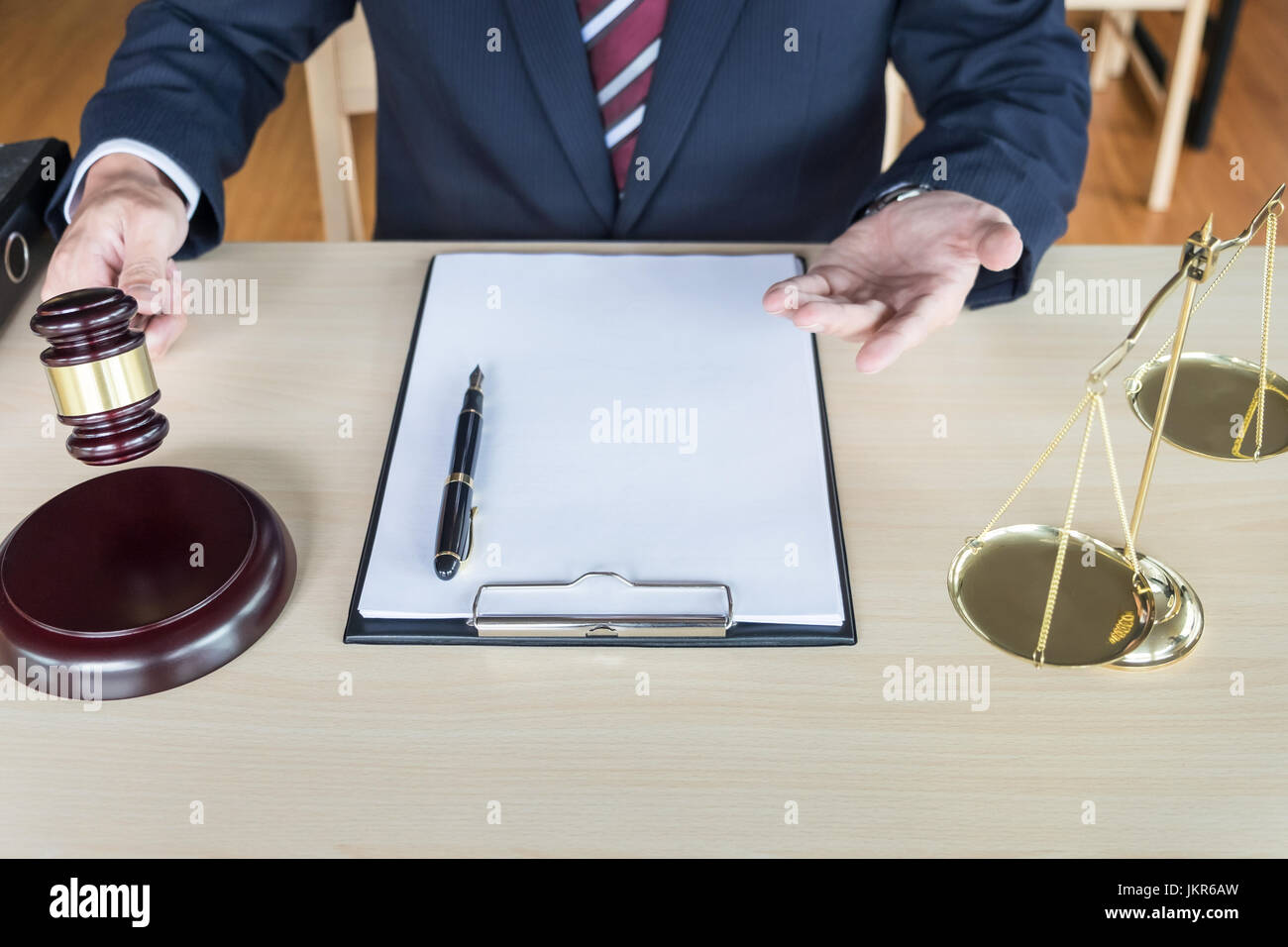 Male Judge In A Courtroom Striking The Gavel on sounding block Stock ...