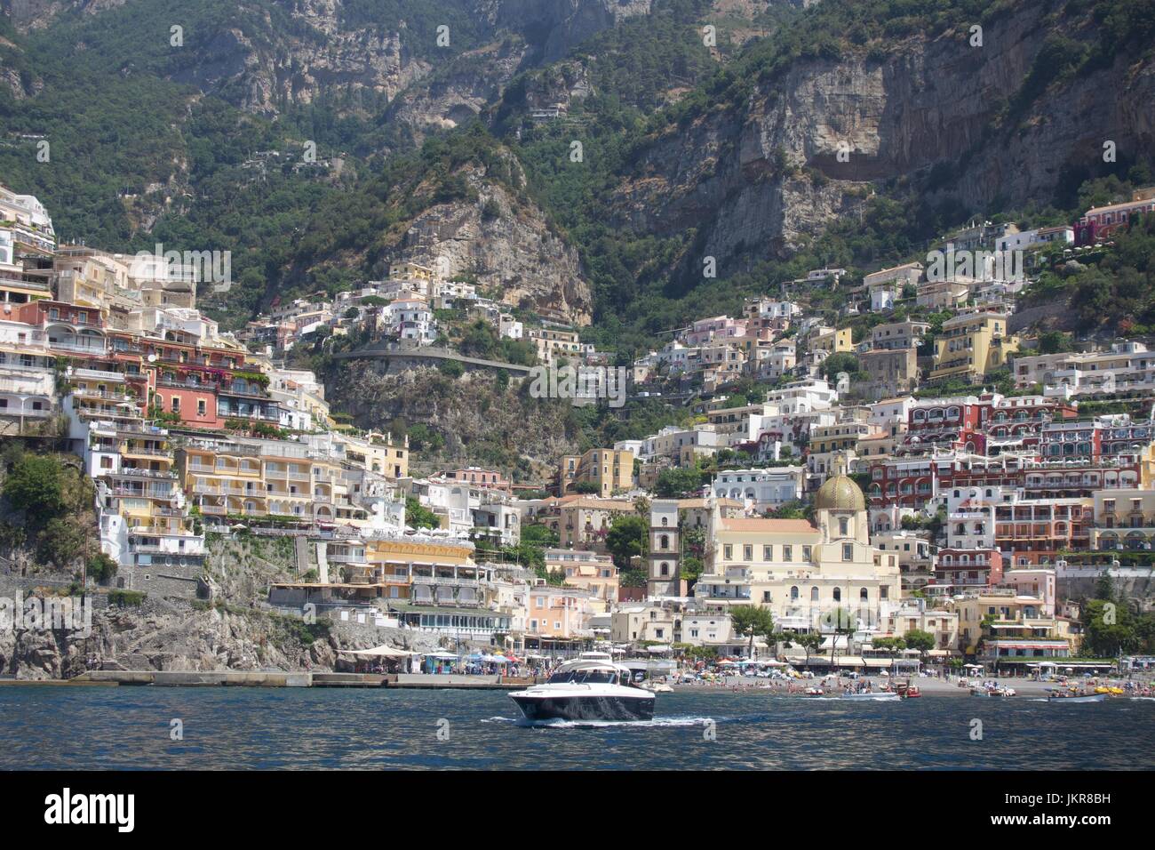 Positano from the sea with boat in foreground Stock Photo - Alamy
