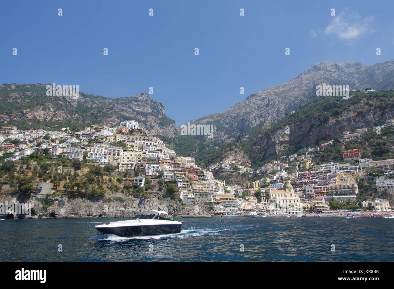 Positano from the sea with boat in foreground Stock Photo - Alamy