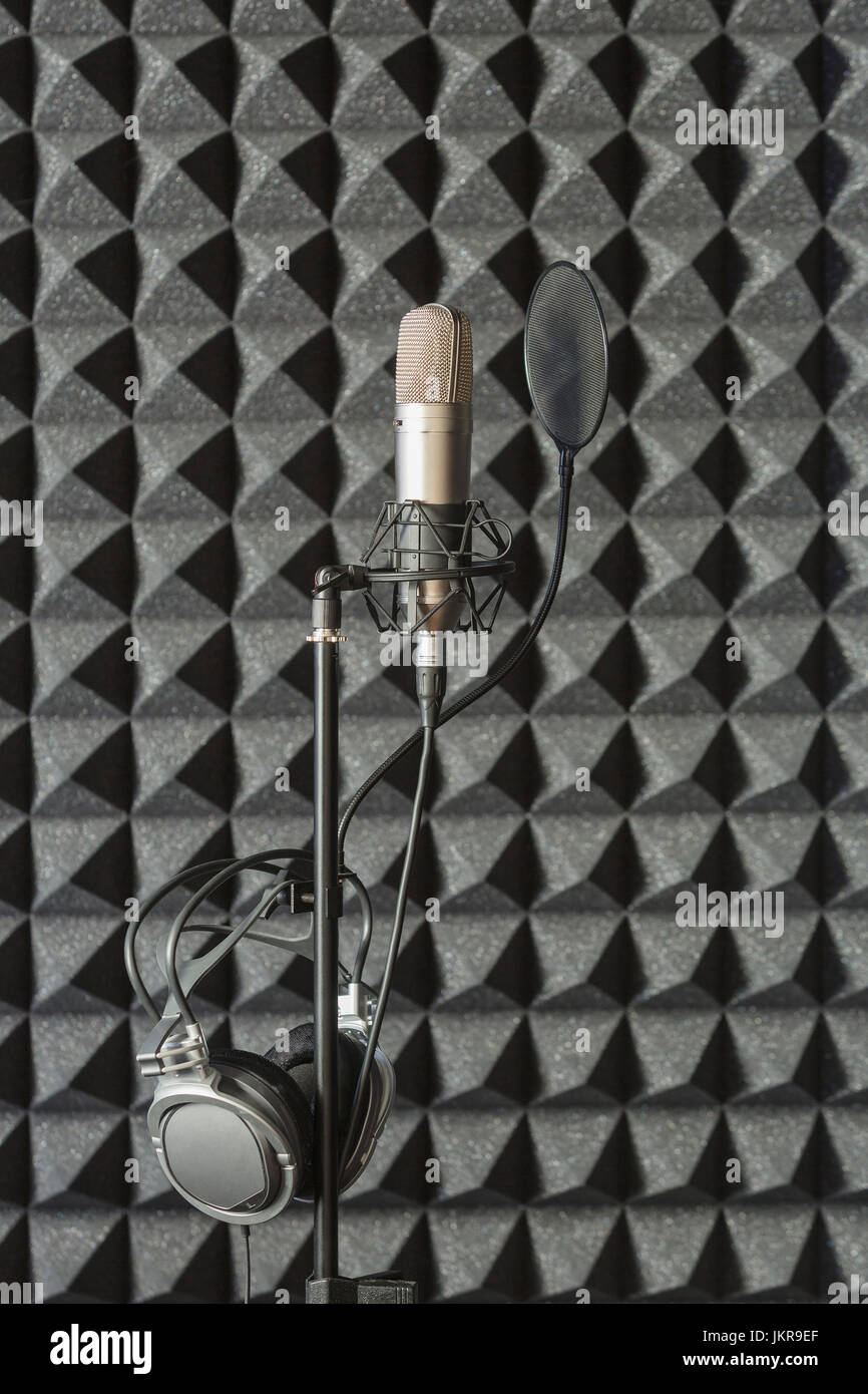 Headphones on microphone stand in soundproof recording studio Stock ...