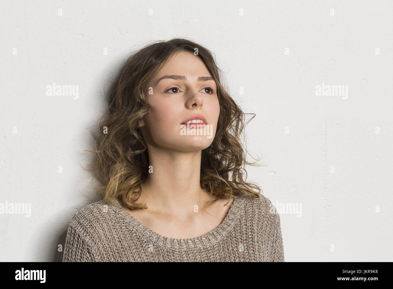 Beautiful woman standing against white background Stock Photo - Alamy