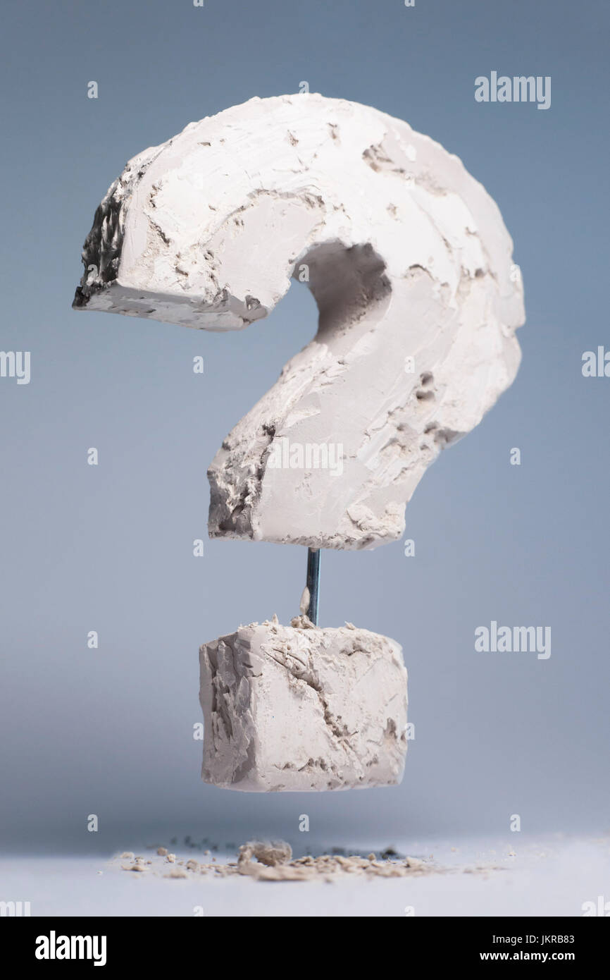 Question mark made of stone material levitating against gray background ...