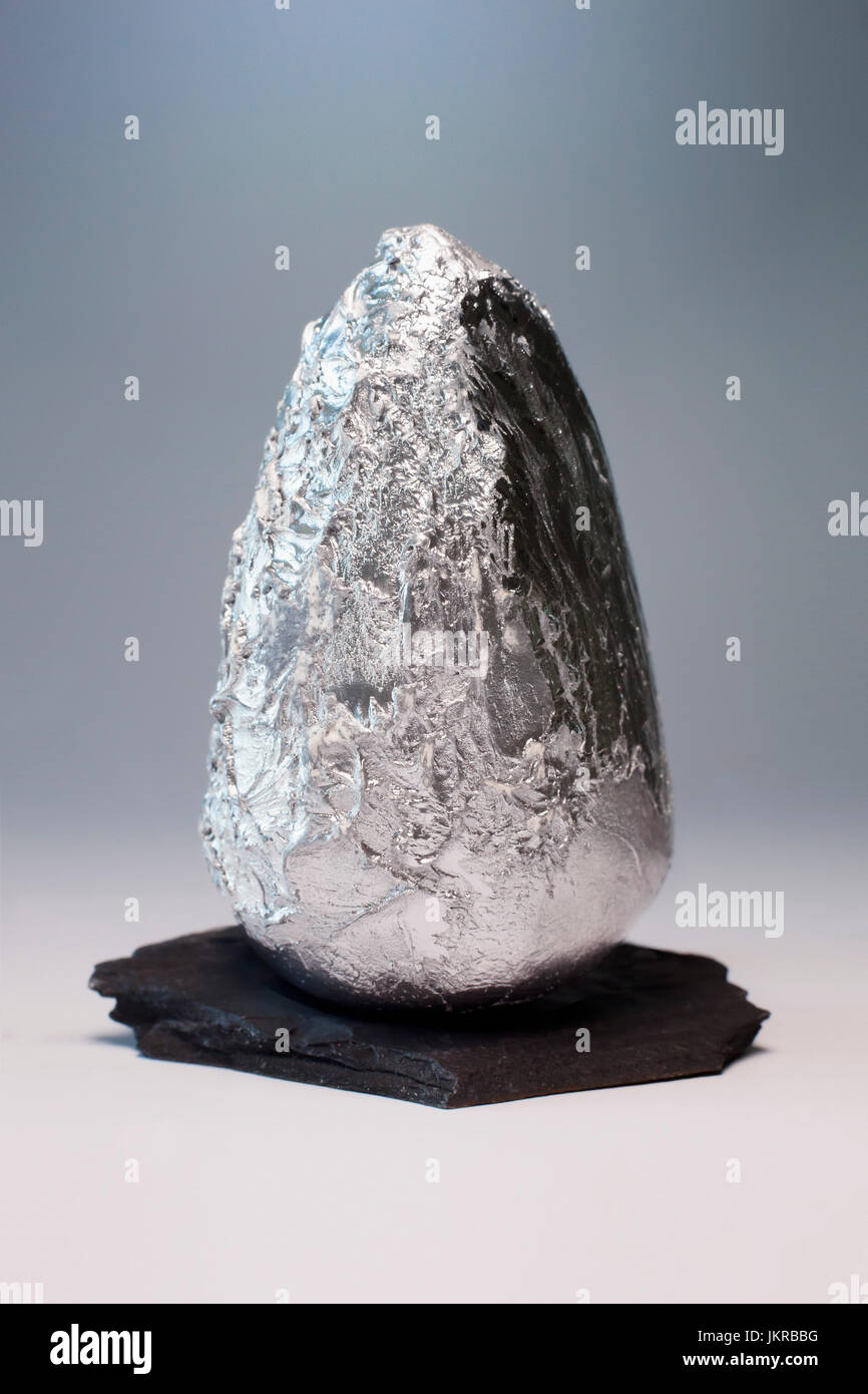 Shiny stone on black material against gray background Stock Photo - Alamy