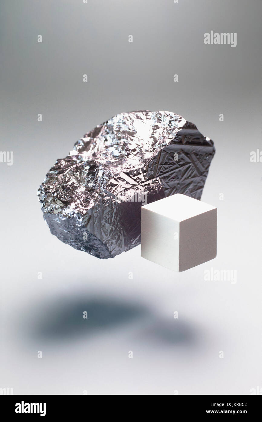 Shiny stone with block shape against gray background Stock Photo - Alamy