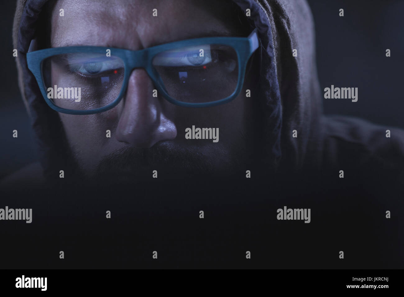 Close-up of serious computer hacker wearing eyeglasses and hood Stock ...