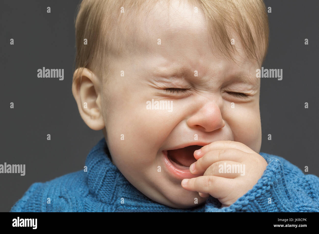 Crying baby with blue eyes close up hi-res stock photography and images ...
