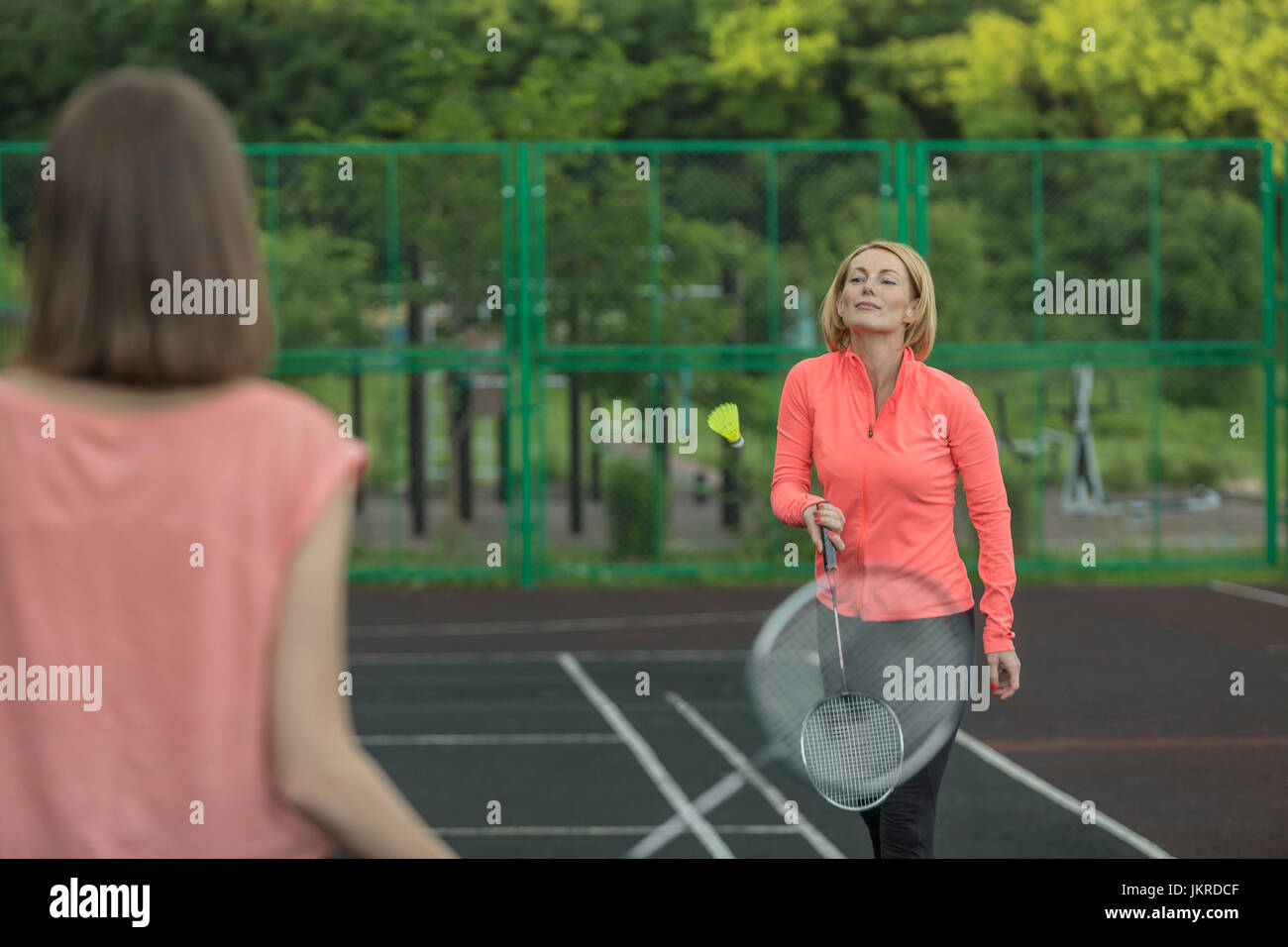 Three people playing badminton in court hi-res stock photography and ...