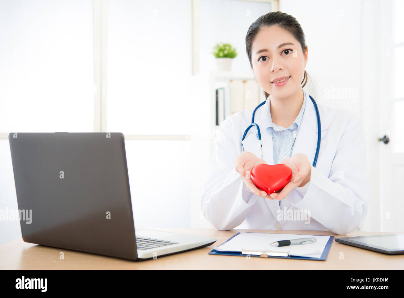 confident young cardiologist woman using online service giving all ...