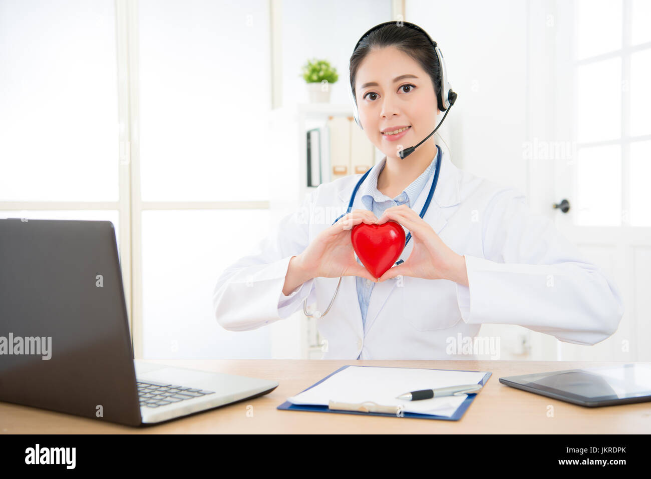 young professional woman right cardiologist holding heart shape and ...