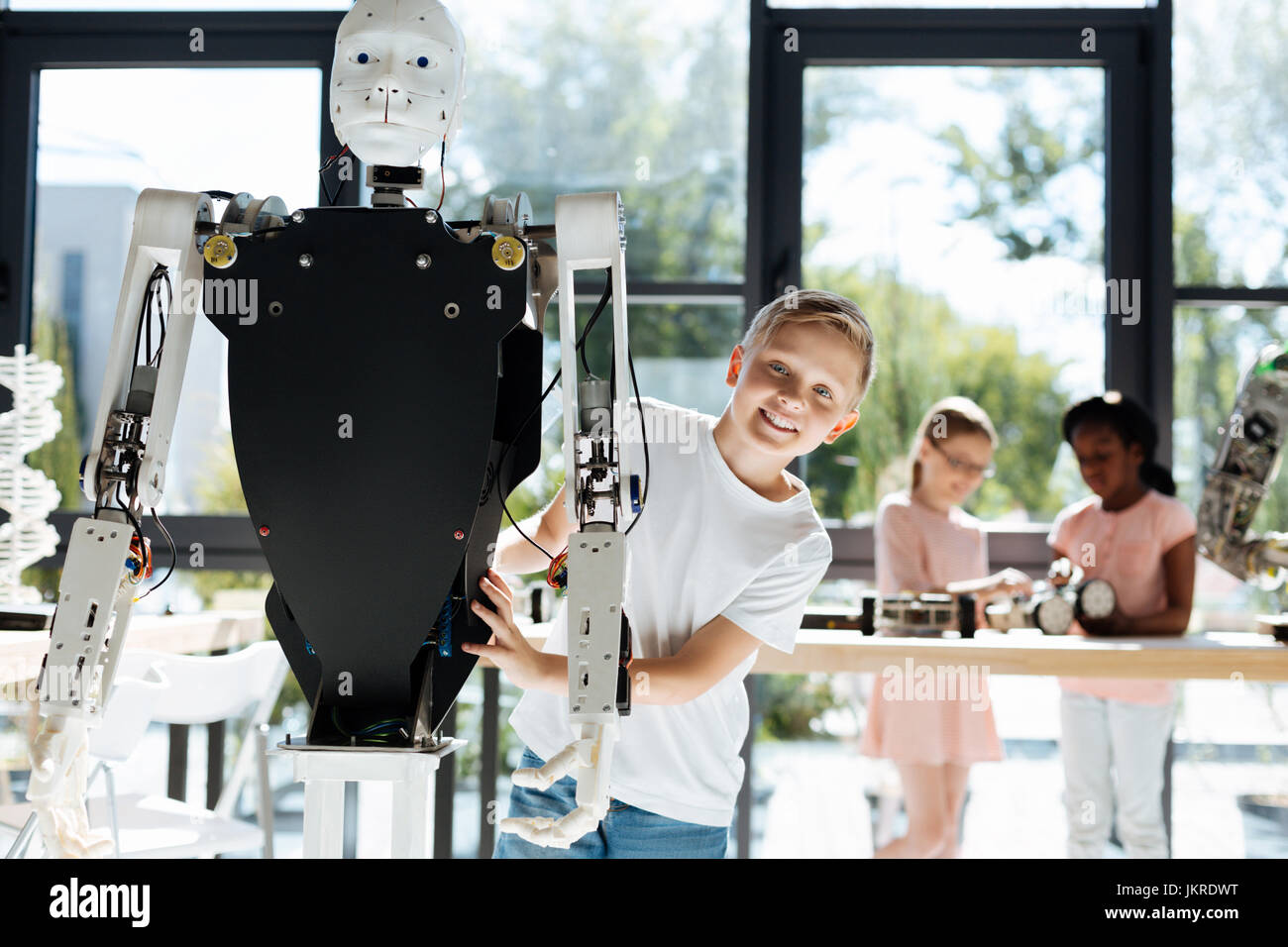 Cheerful little boy posing with a human robot Stock Photo - Alamy