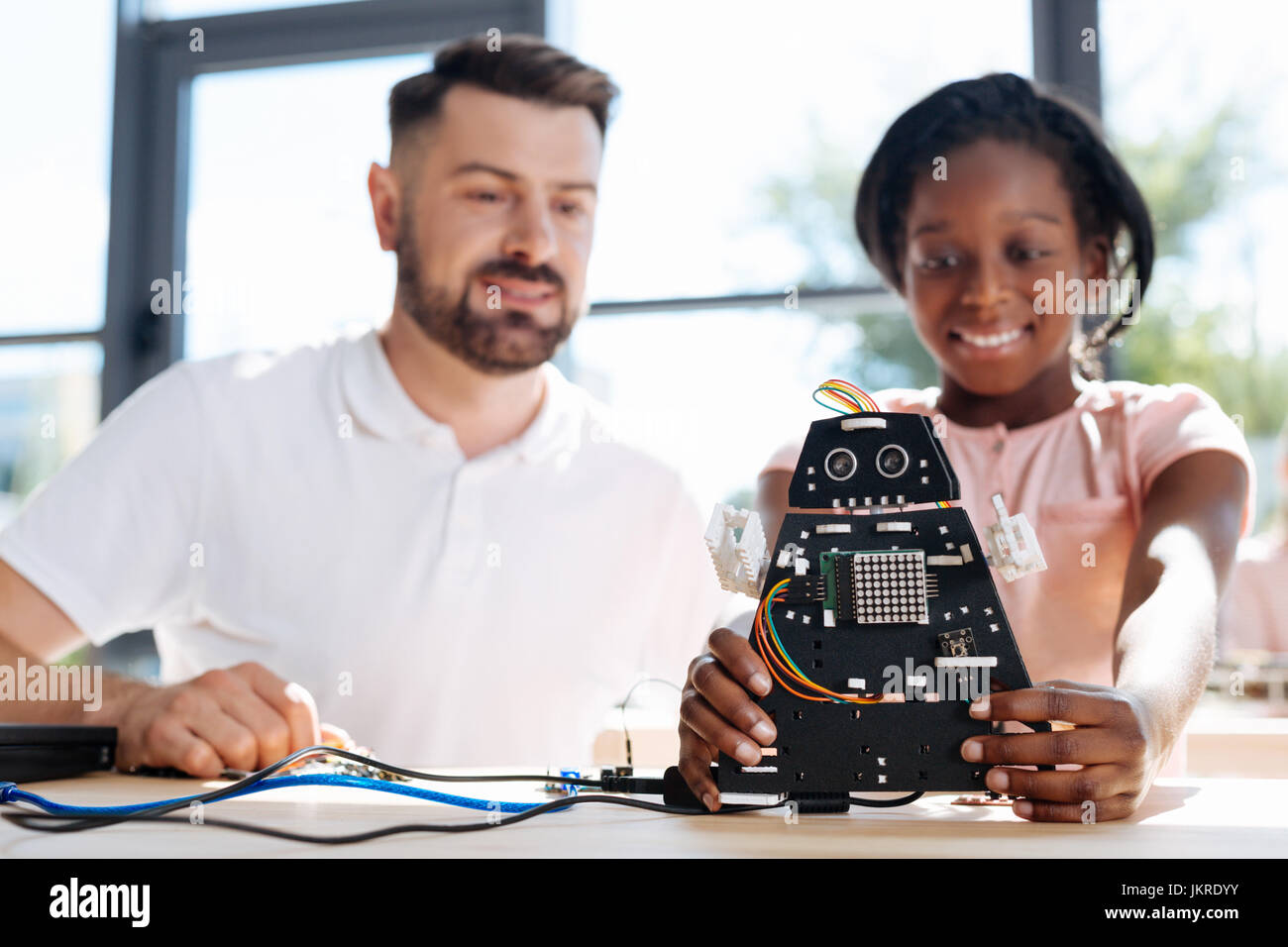 Happy student admiring robot of own creation Stock Photo - Alamy
