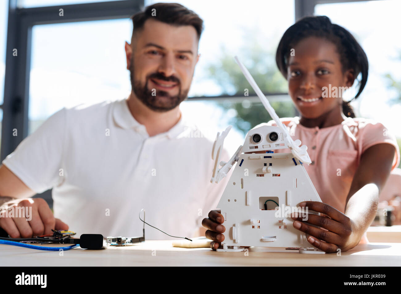 Teacher and student posing with a new robot Stock Photo - Alamy