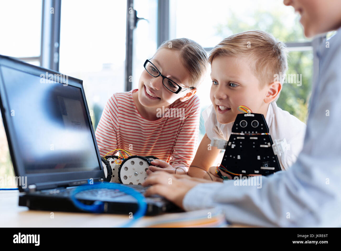 Lovely children checking out new software Stock Photo - Alamy