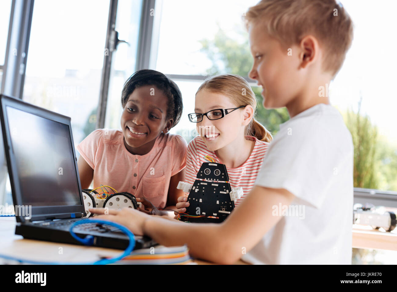 Fair-haired boy showing tutorial video to his friends Stock Photo - Alamy