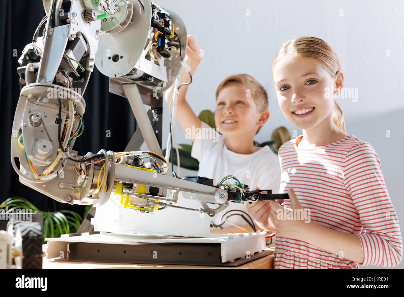 Happy kids taking part in the construction of robot Stock Photo - Alamy