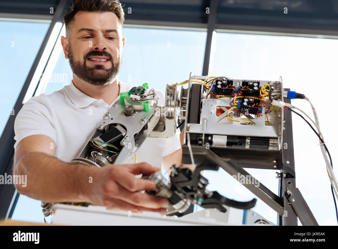 Handsome man trying out the performance of hand mechanism Stock Photo ...