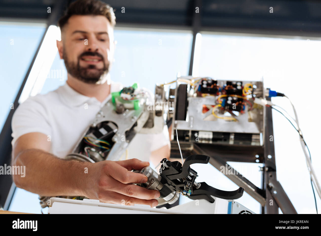 Handsome man holding a hand of a future human robot Stock Photo - Alamy