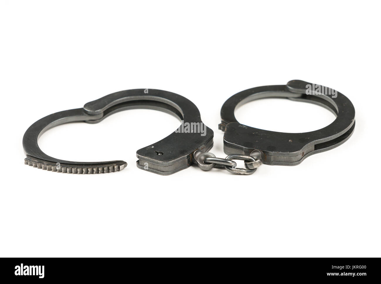 Metal police handcuffs on white background Stock Photo - Alamy