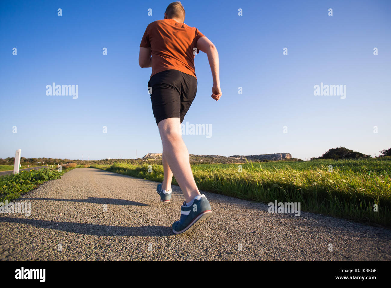 Man running outdoor sprinting for success. Male fitness runner sport ...