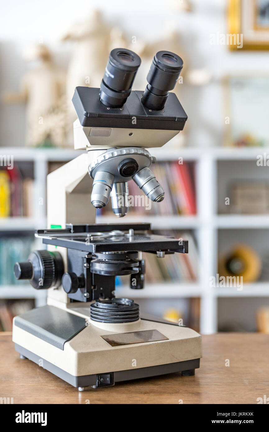 Microscope with education school background Stock Photo - Alamy