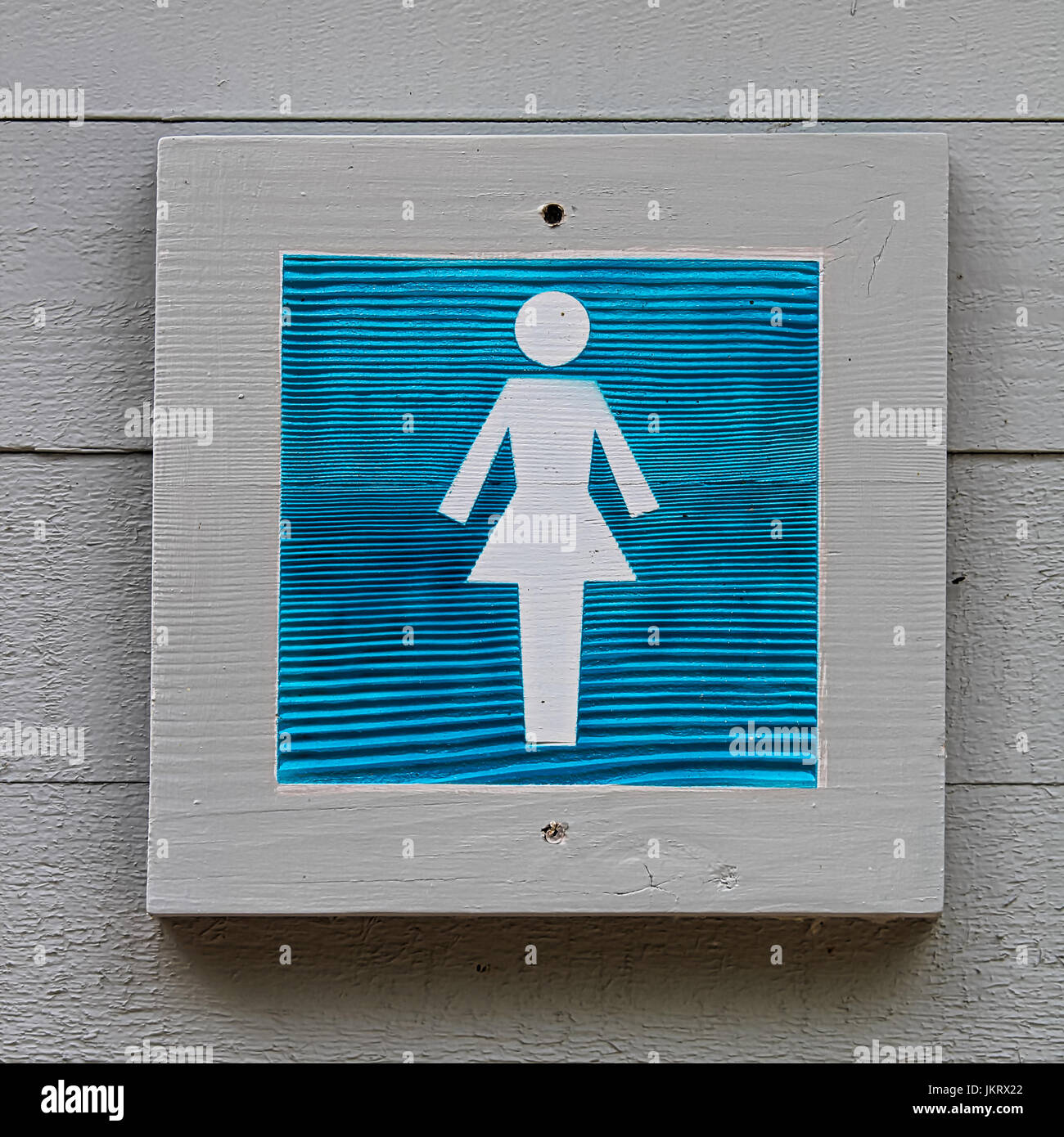 A wooden blue female bathroom sign Stock Photo - Alamy