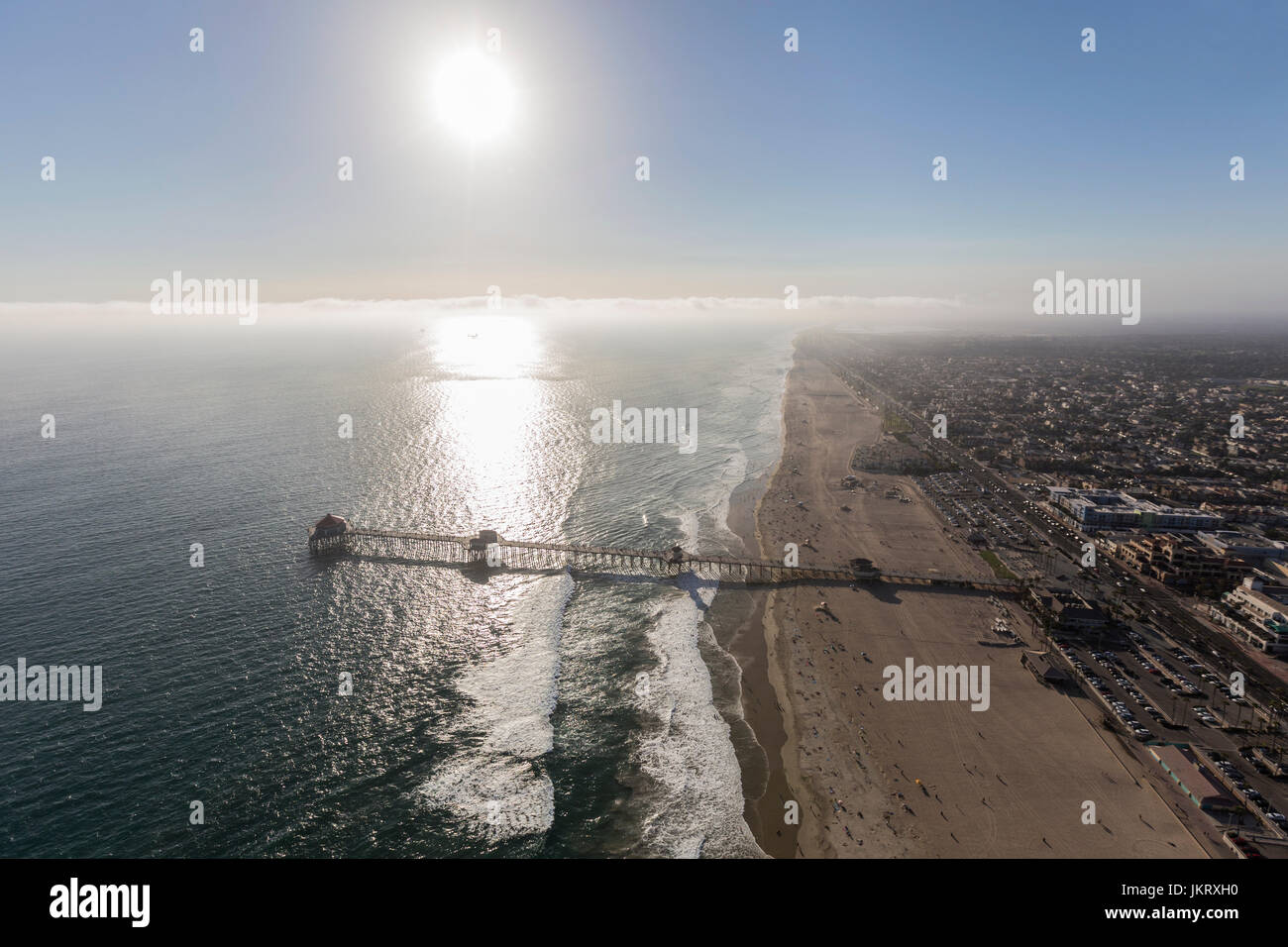 Aerial view of Huntington Beach Pier with late afternoon sun in ...