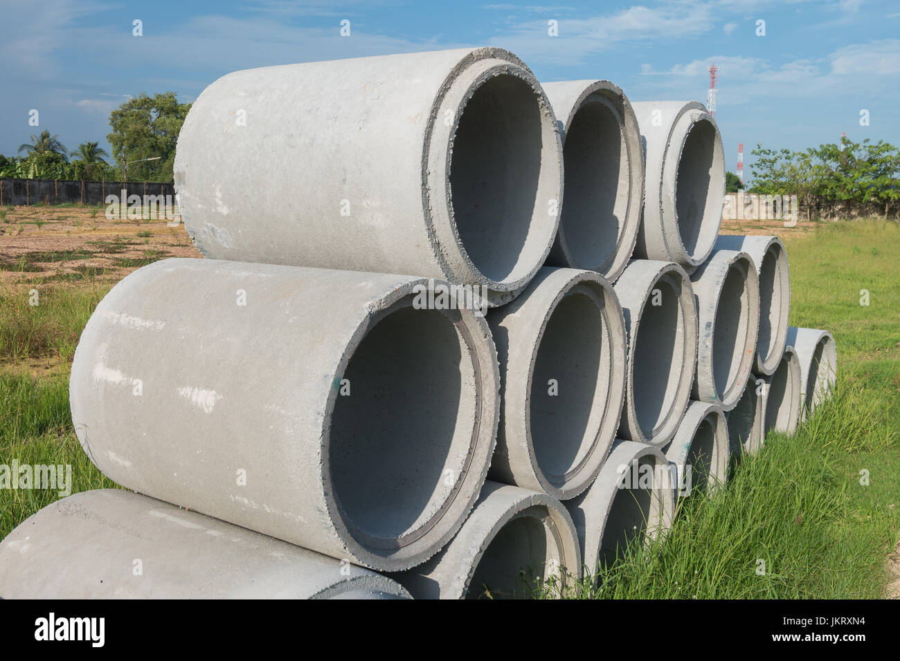 Stacked concrete pipes on a construction site Stock Photo - Alamy