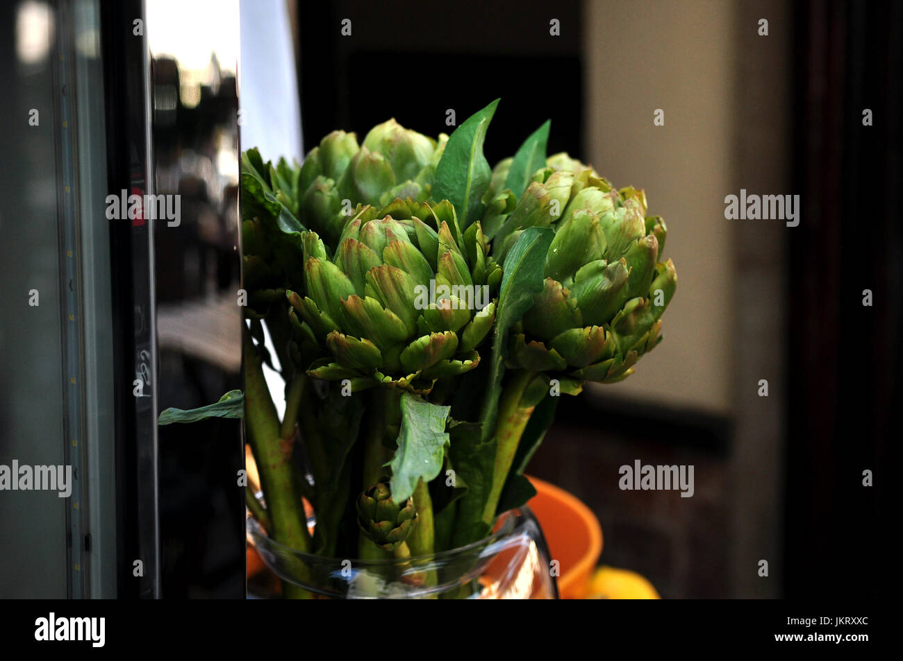 Artichoke inside a glass by the refrigerator Stock Photo - Alamy
