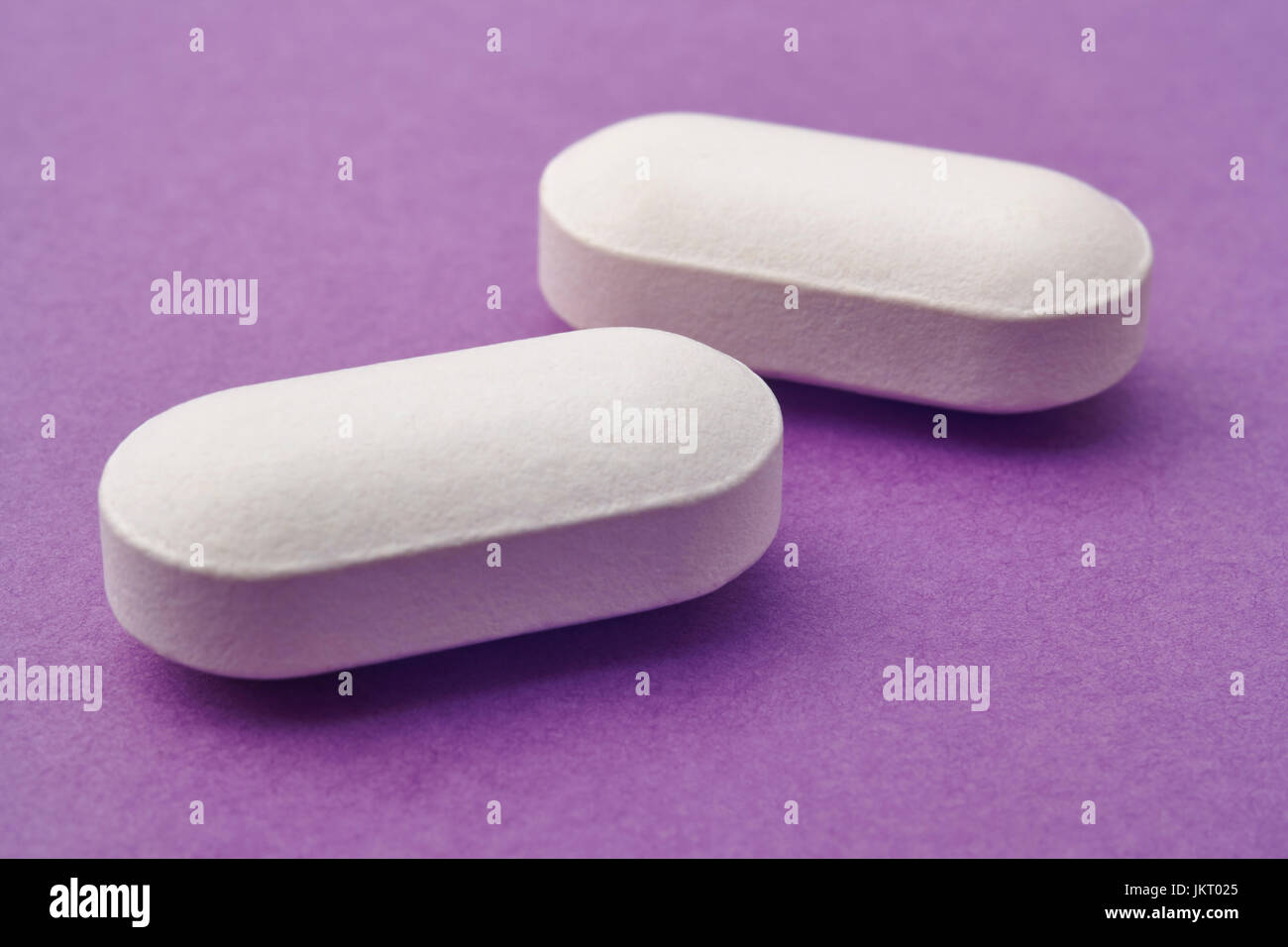 Pills over a purple background. Medicament treatment. Health care photo ...
