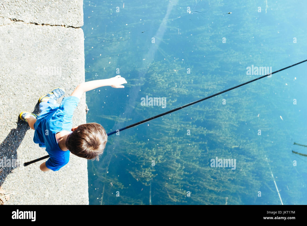 Child fishing at the harbor Stock Photo - Alamy