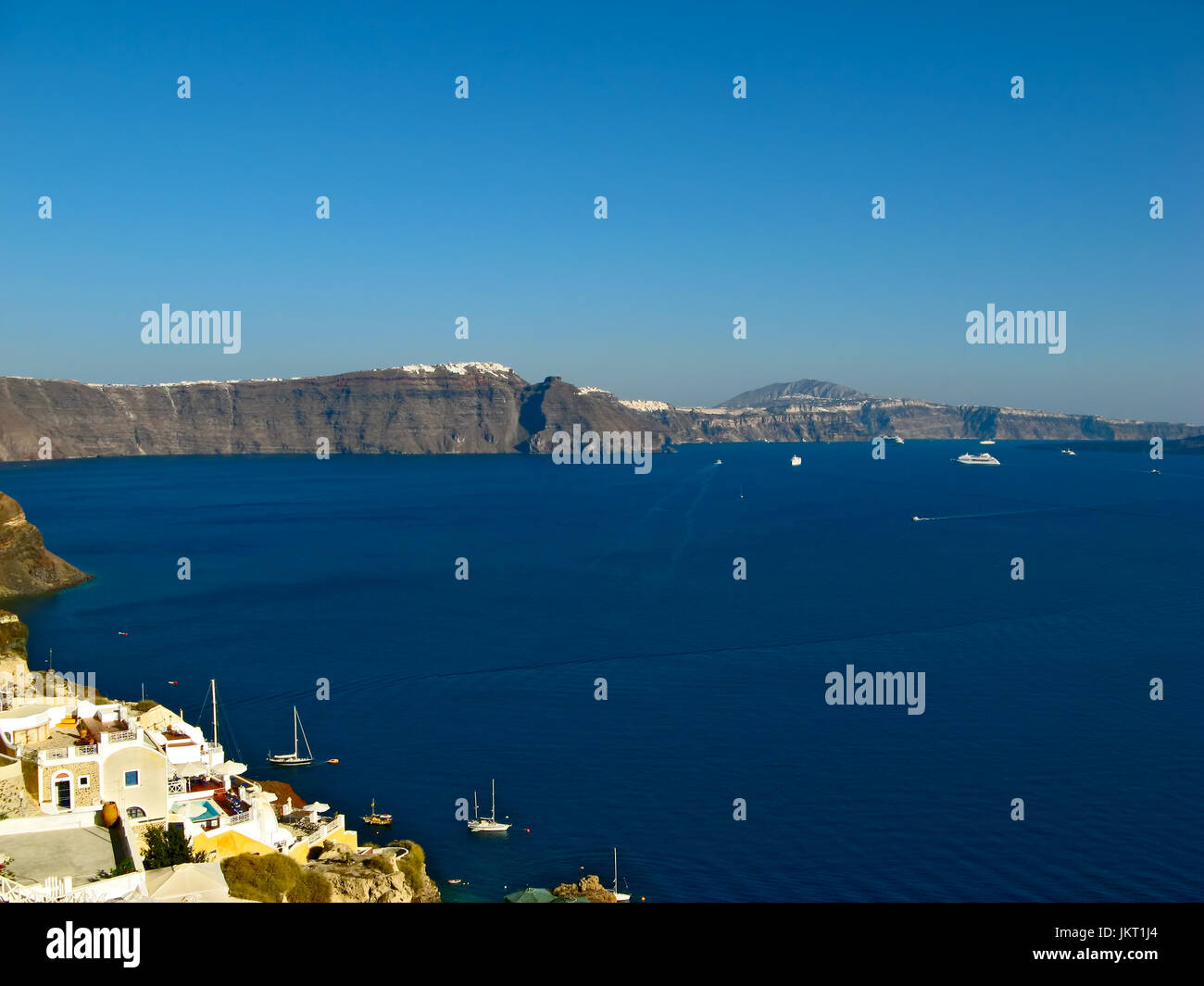 Santorini volcano caldera lit by afternoon sunshine, view from Oia ...